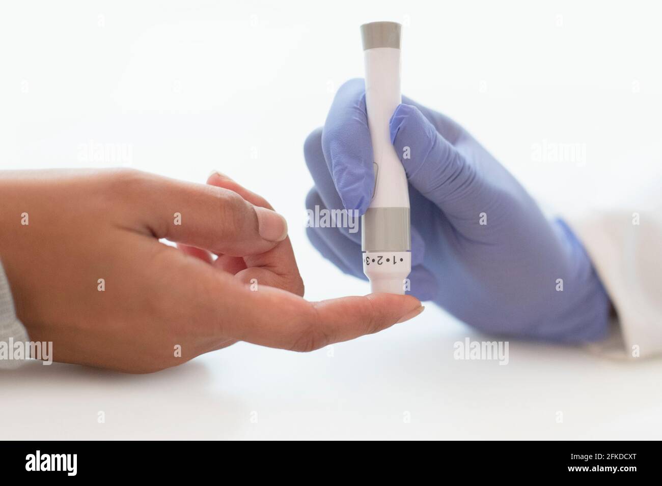 Taking finger prick blood sample Stock Photo - Alamy