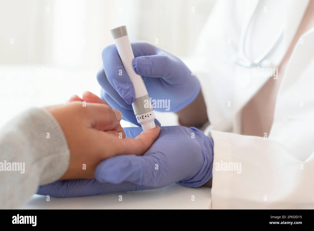 Taking finger prick blood sample Stock Photo - Alamy