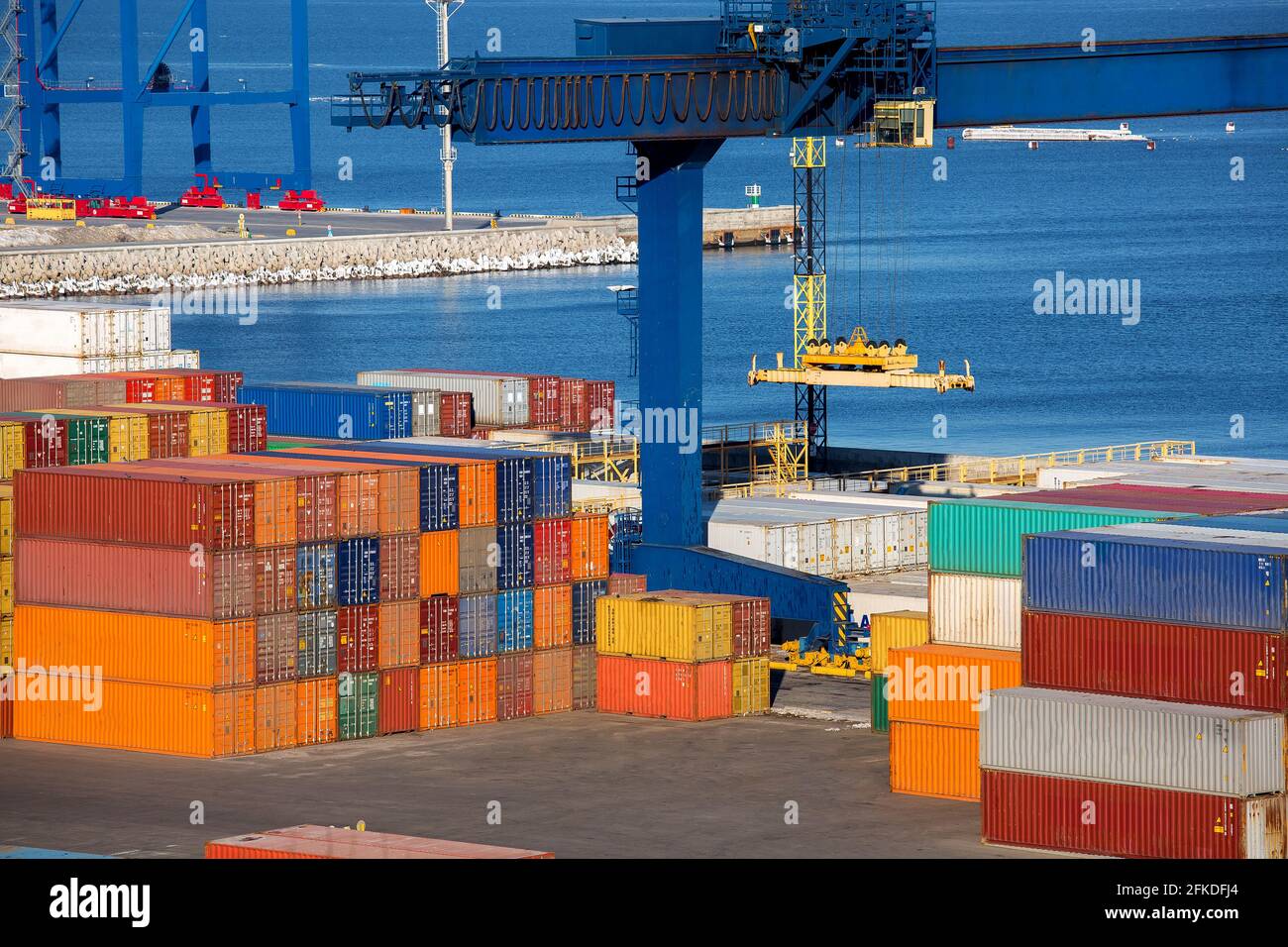 heavy lifting crane for unloading and sorting multi-colored containers ...