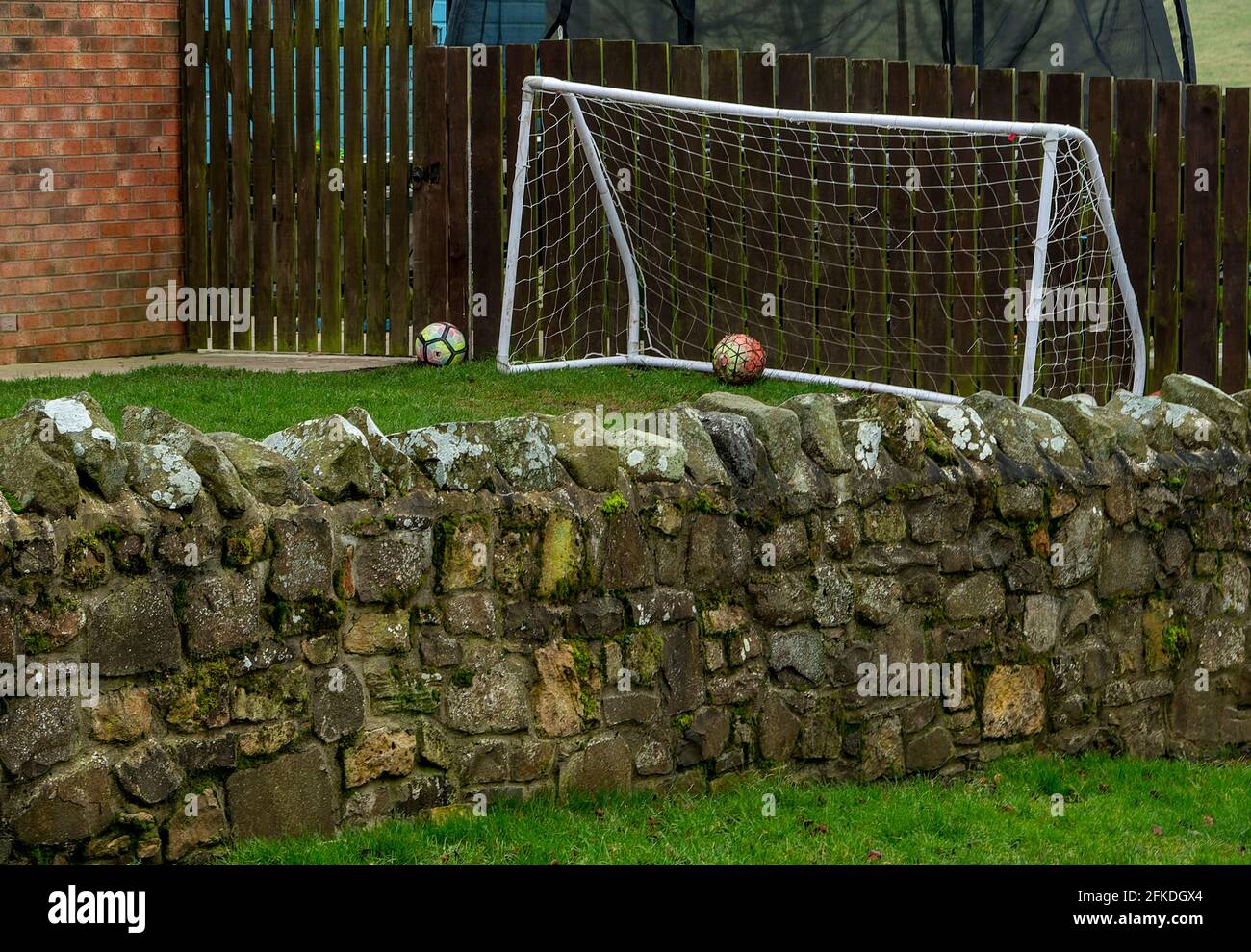 Miini soccer pitch behind a stone wall in an English village Stock ...