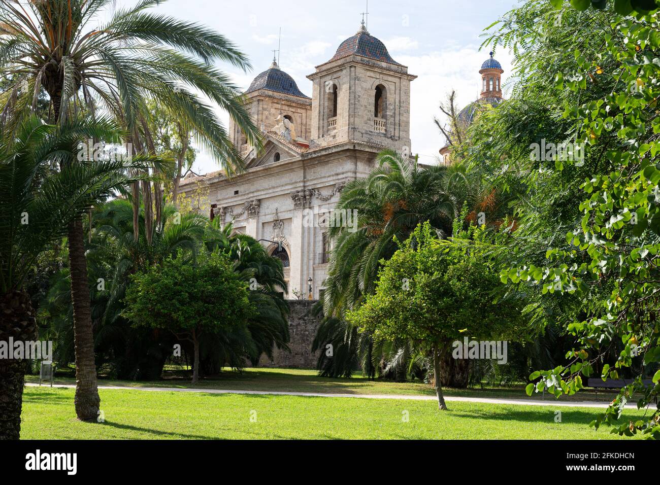 Church seen trough some big trees from old Turia riverbed. Valencia ...