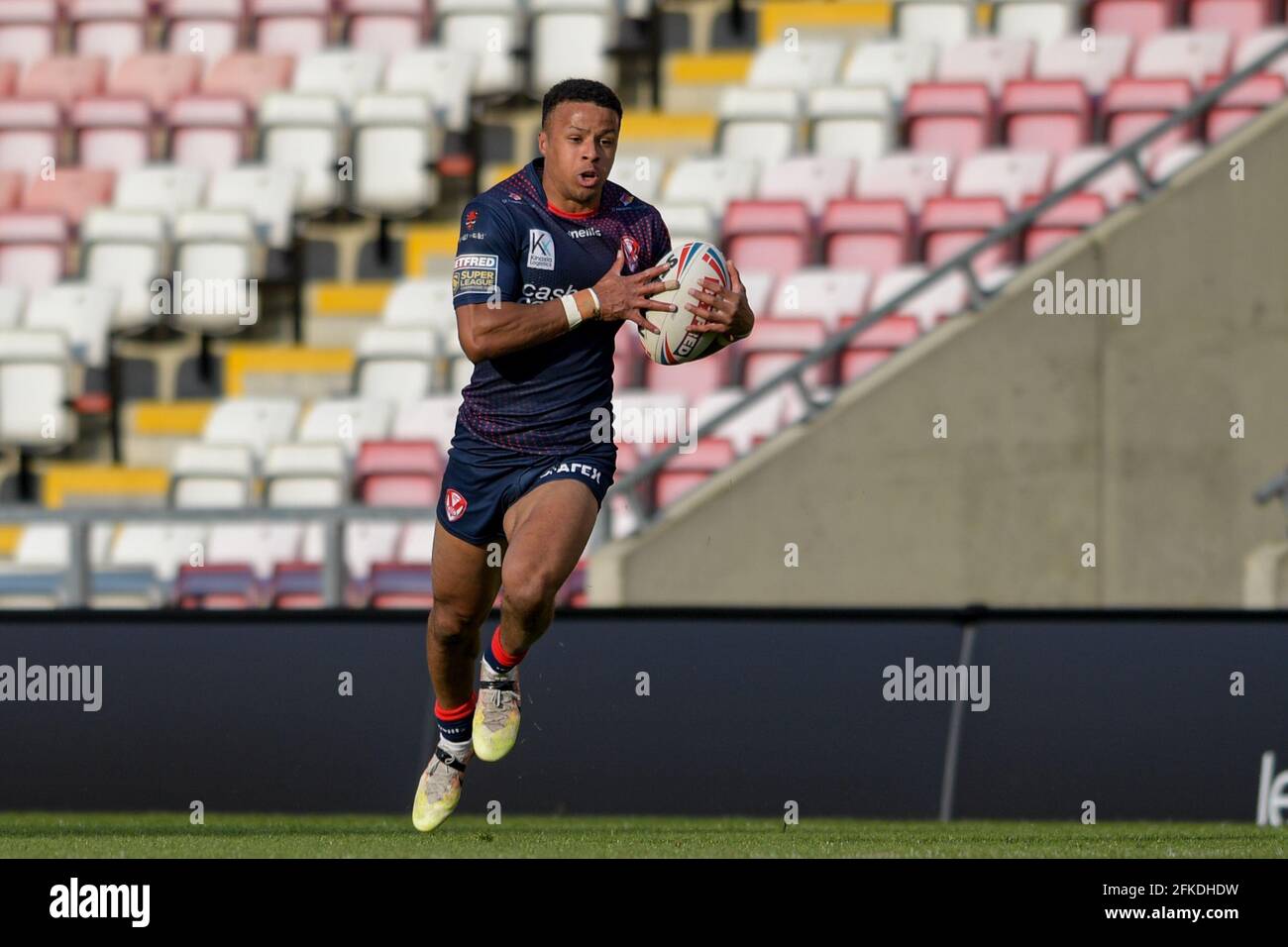 Leigh, UK. 30th Apr, 2021. Regan Grace (5) of St Helens runs forward ...