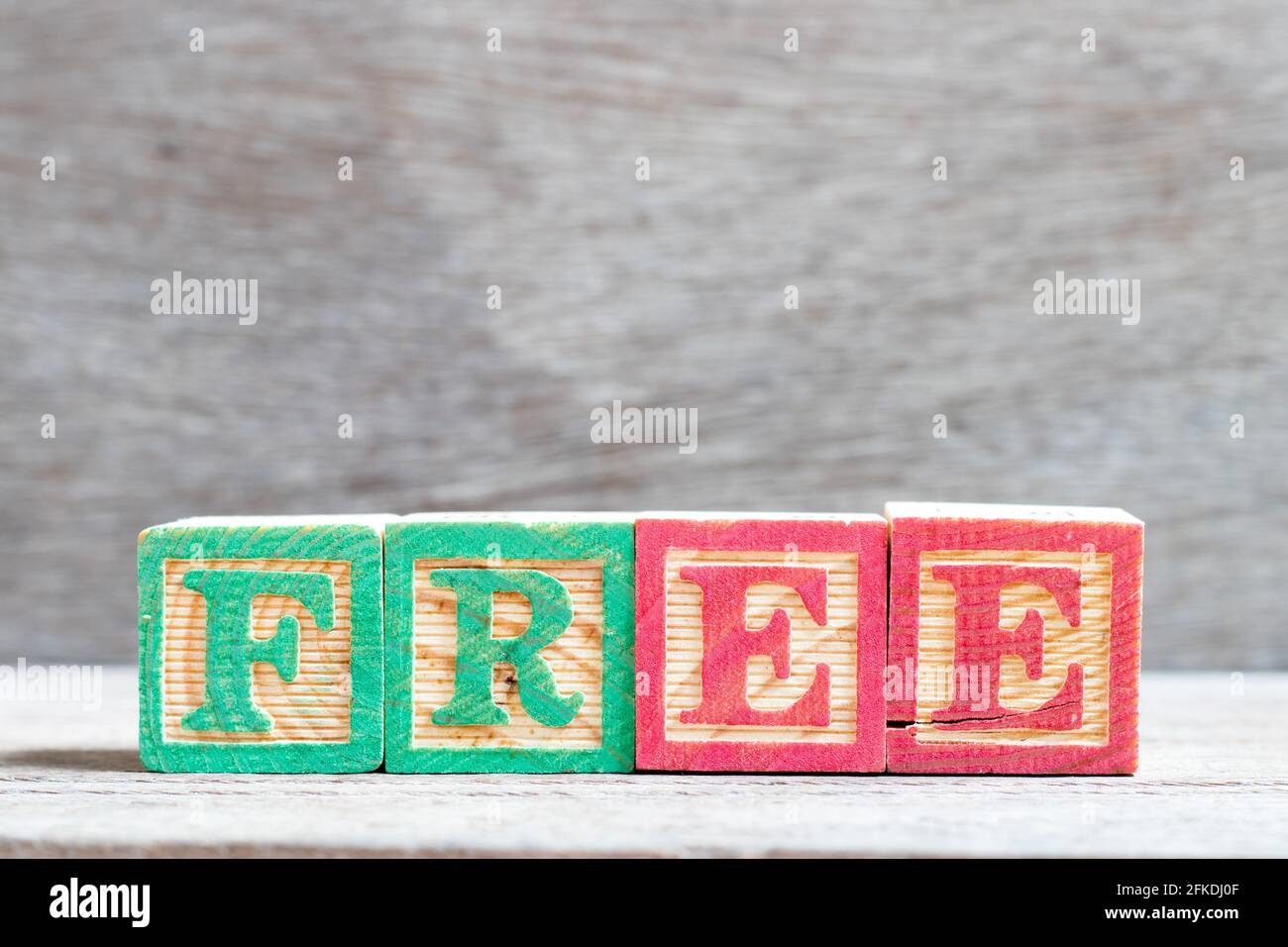 Color letter block in word free on wood background Stock Photo - Alamy