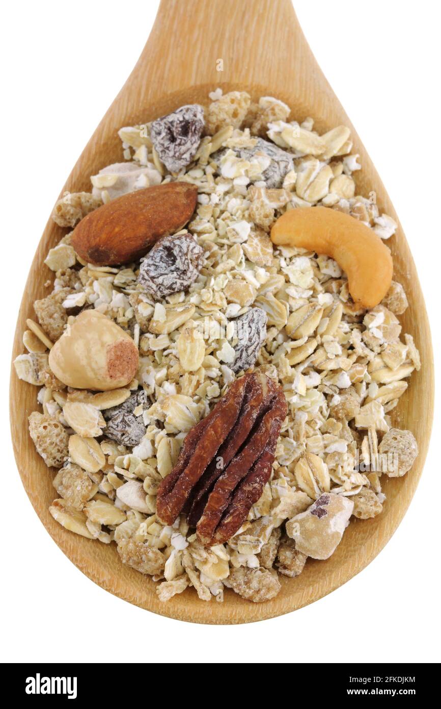 A spoon of Fruit, Nut, and Fiber Muesli isolated on white background ...