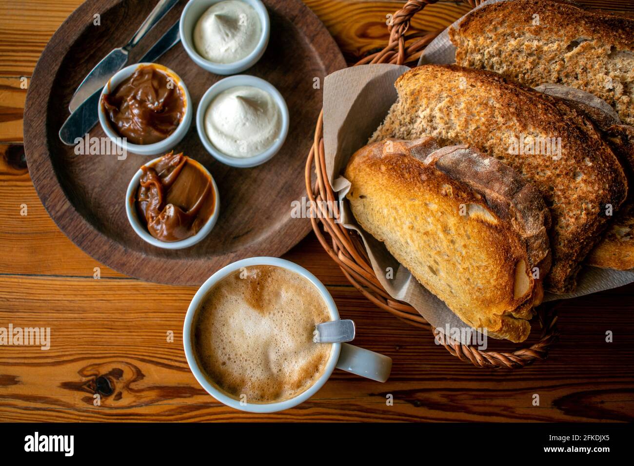 Coffee with milk (latte) and country toasts with dulce de leche and ...