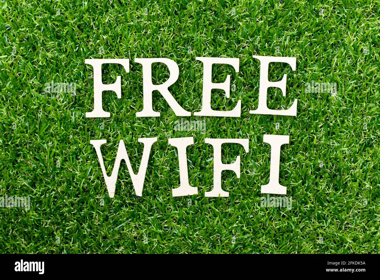 Wood alphabet letter in word free wifi on green grass background Stock ...