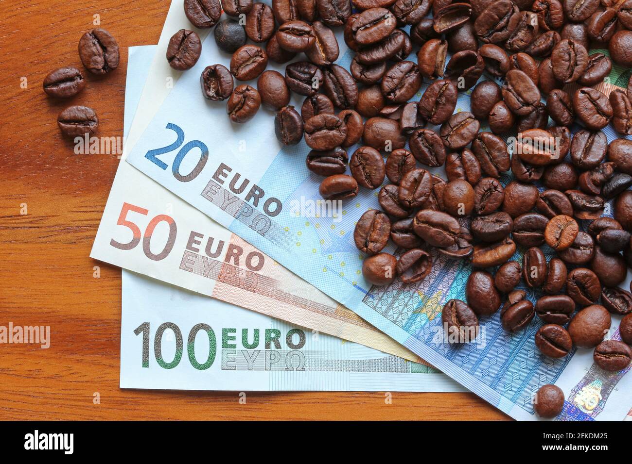 Coffee beans on top of Euro banknotes money Stock Photo - Alamy