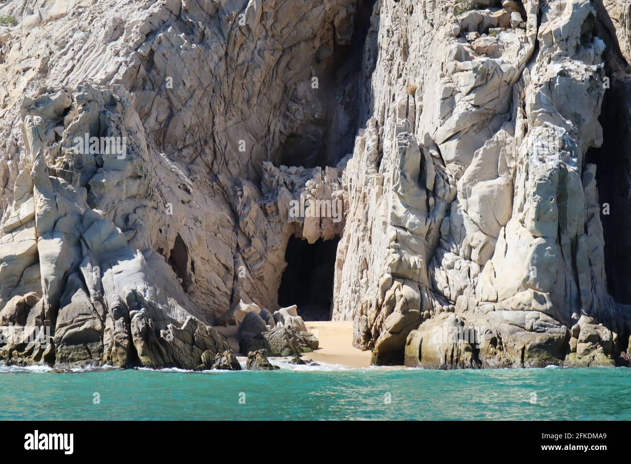 Beautiful view of the rugged rocky seaside landscape with a hole in the ...