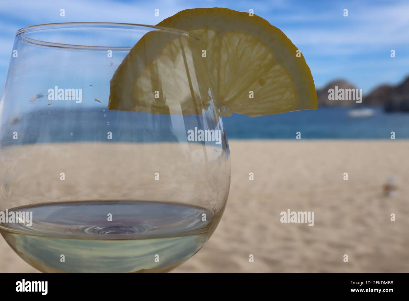 Closeup of a tequila drink with lemon garnish at the beach in Los Cabos ...