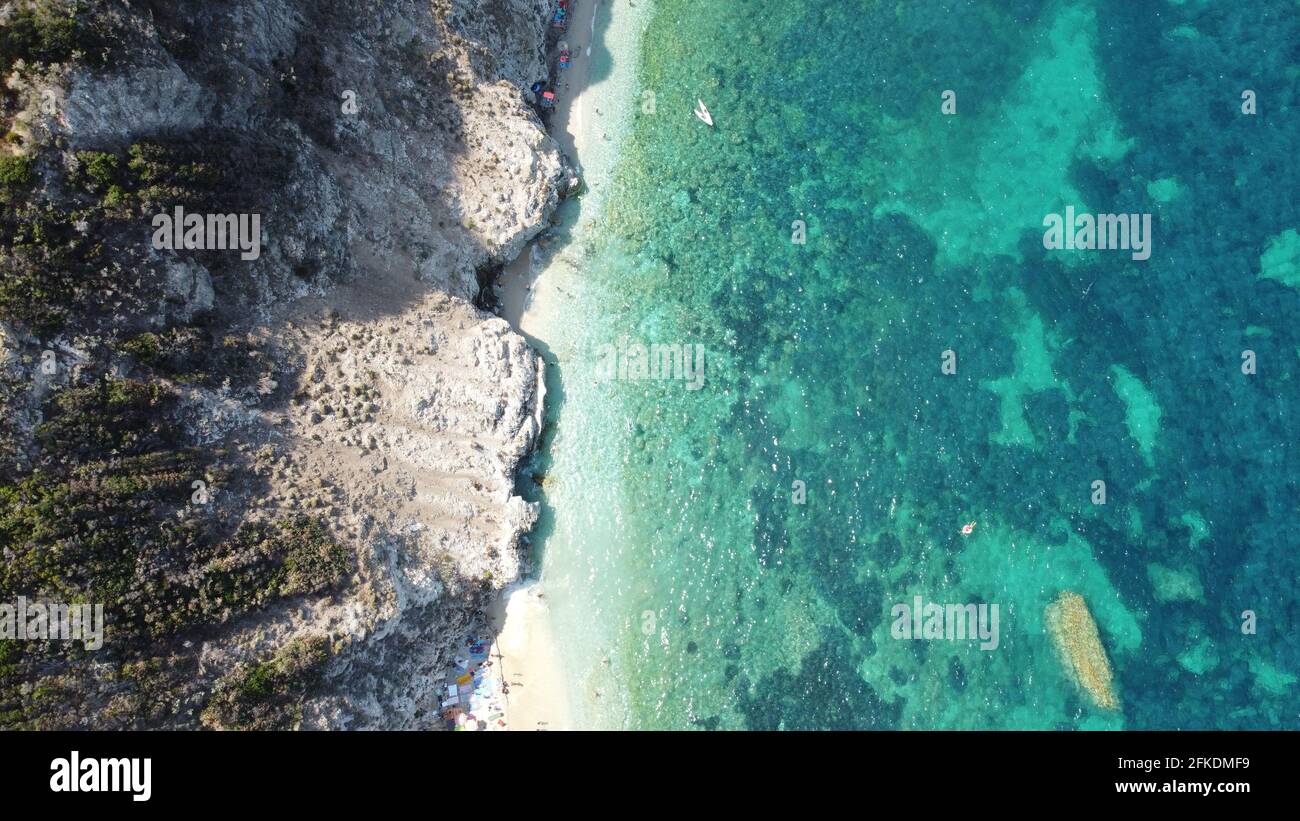 Aerial view of the coastline washed by blue ocean waves at the Tuscan ...