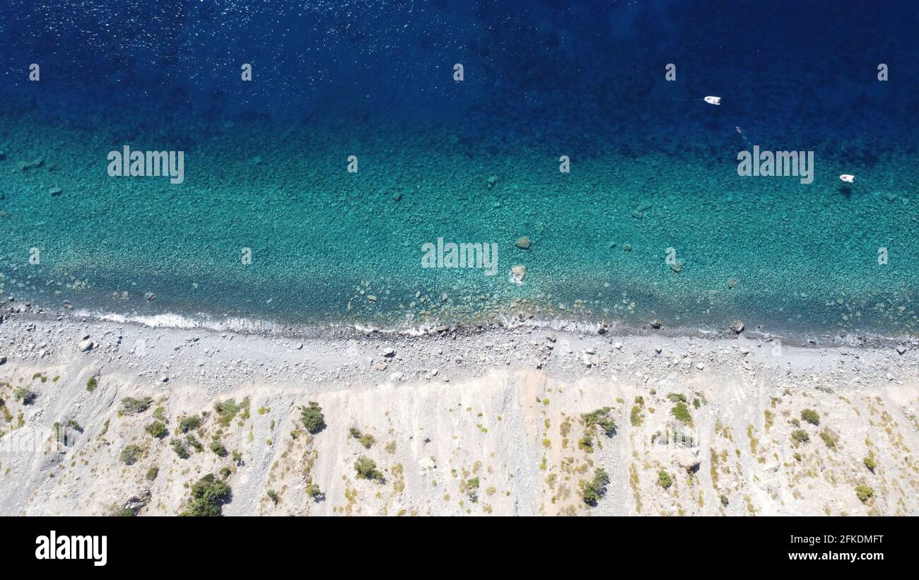 Aerial view of the coastline washed by blue ocean waves at the Tuscan ...