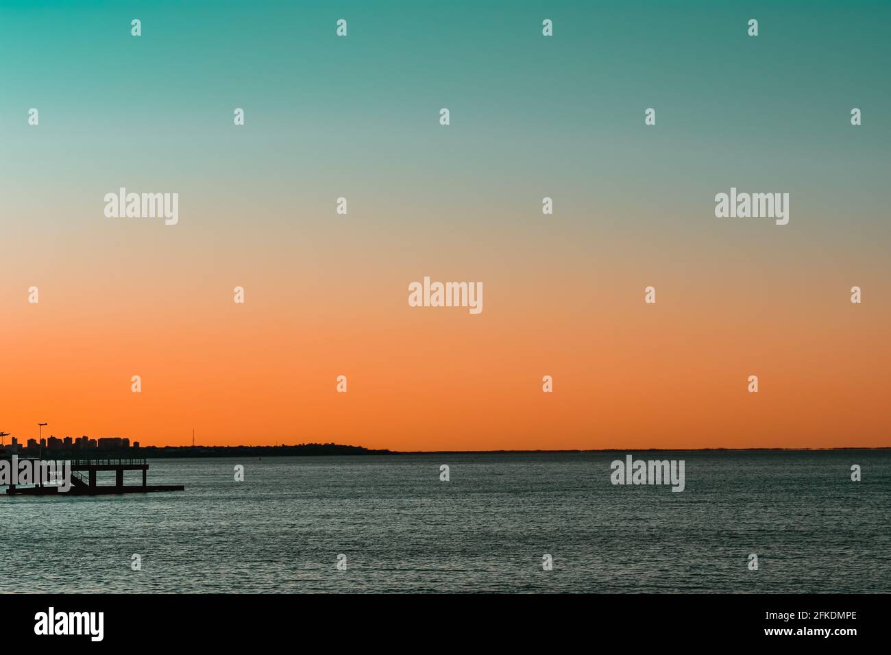Beautiful sunset view across the ocean and pier Stock Photo - Alamy