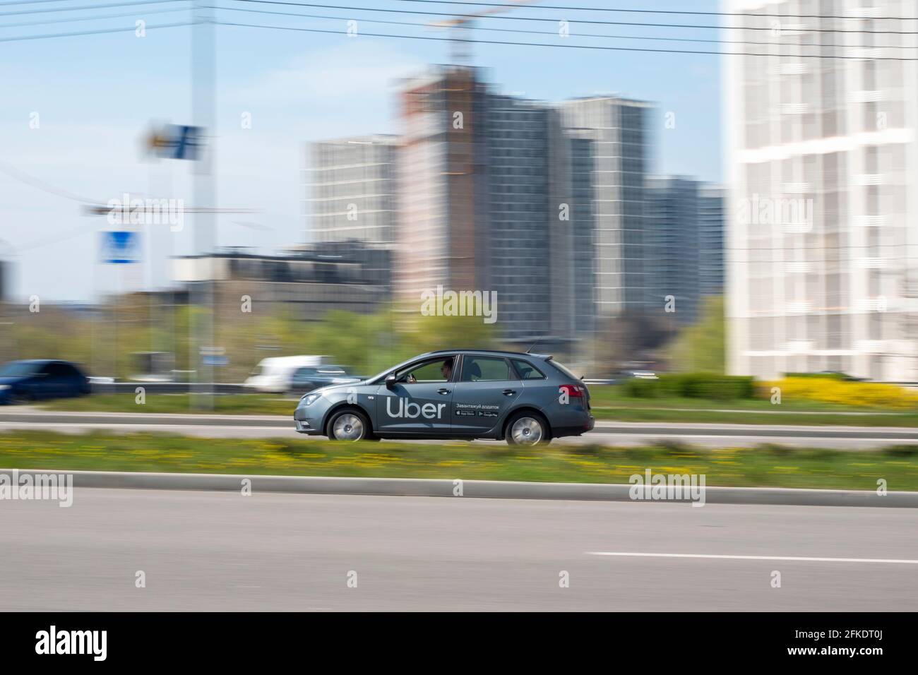 Ukraine, Kyiv - 20 April 2021: Gray Taxi Uber car moving on the street ...