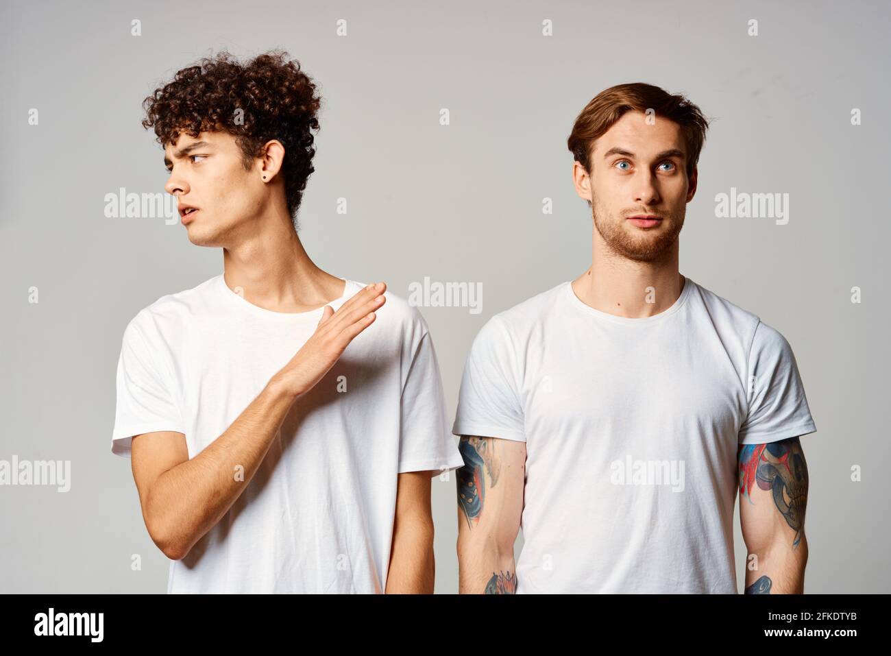 two man in white t-shirts are standing next to friendship emotions ...