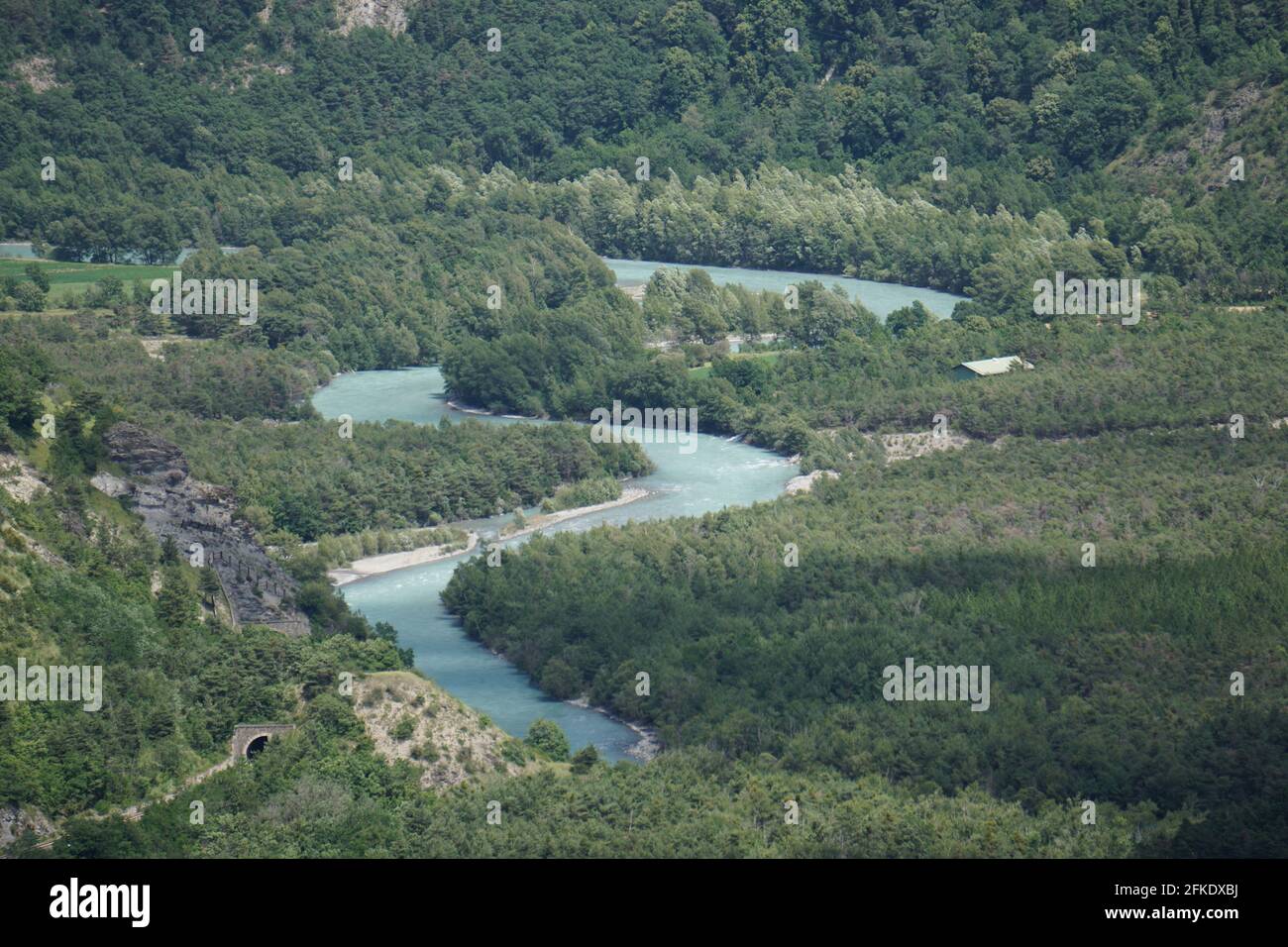 the durance river meandering through the valley in the mountains of ...