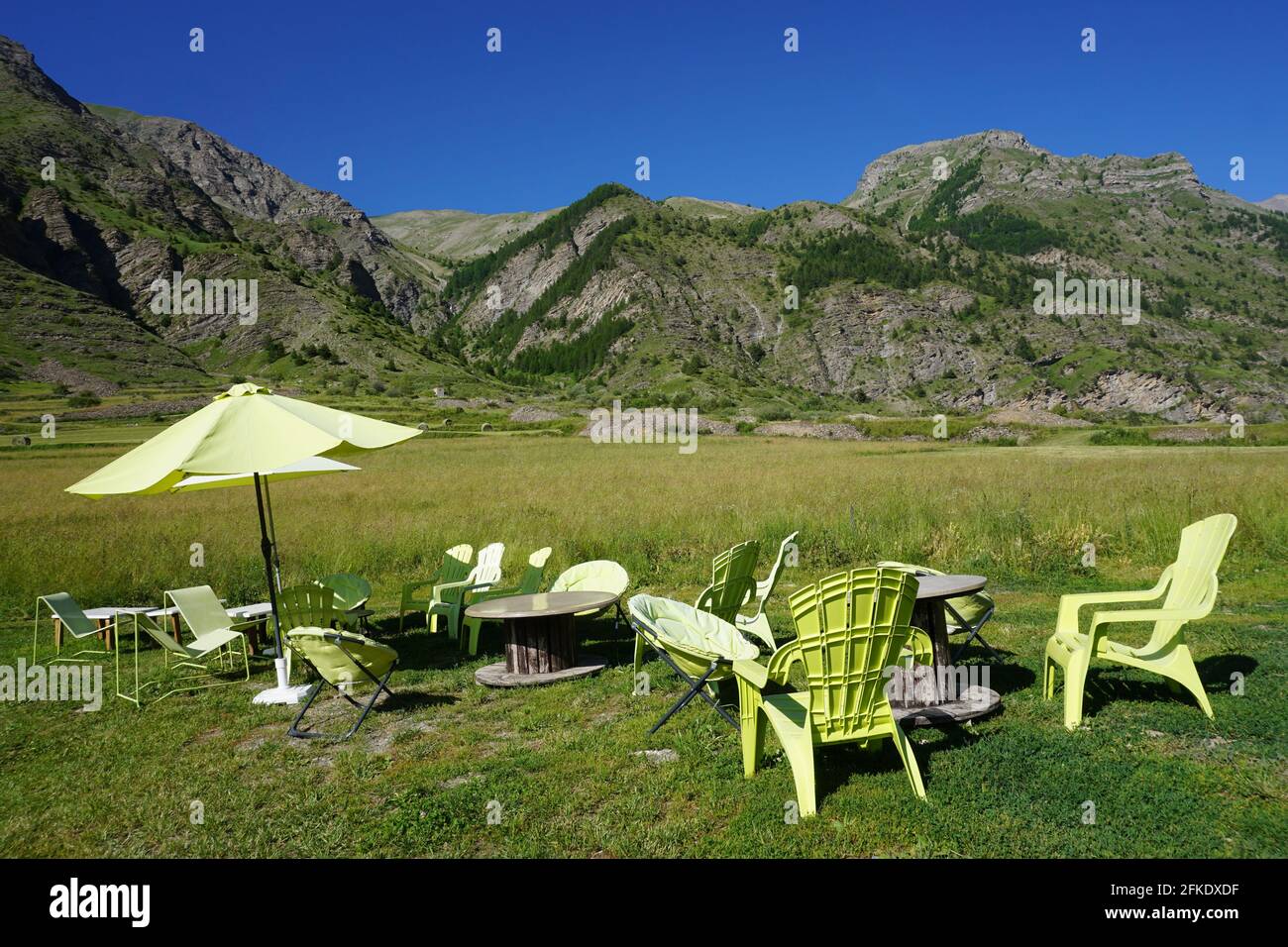 outdoor tables, umbrella and chairs from a cafe in the mountains of ...