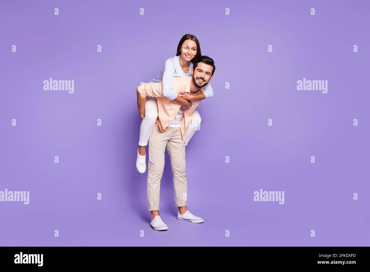 Full length photo of man and woman piggyback ride free time weekend ...