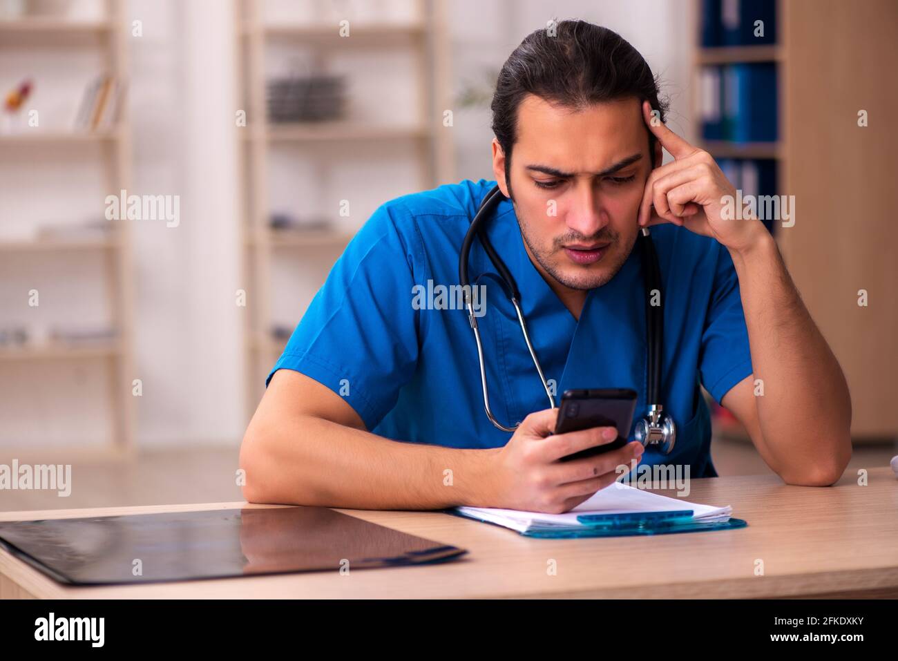 Young doctor working in the clinic Stock Photo - Alamy