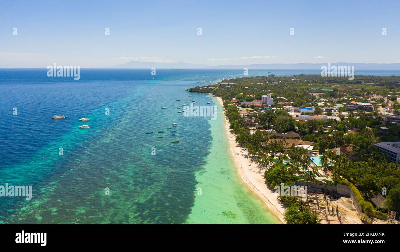 Tropical sandy beach with palm trees and turquoise clear waters. Alona ...