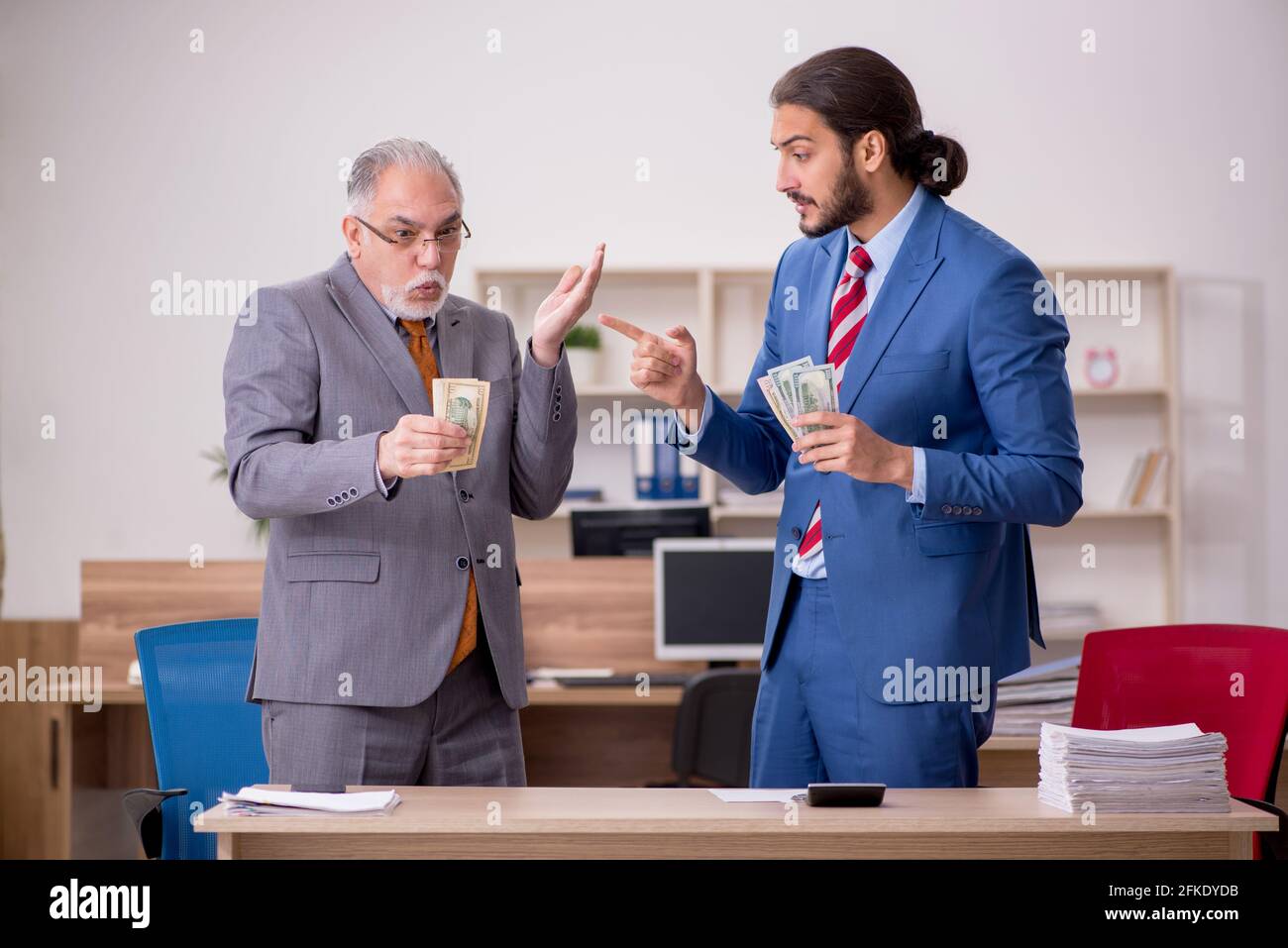 Two employees in remuneration concept Stock Photo - Alamy