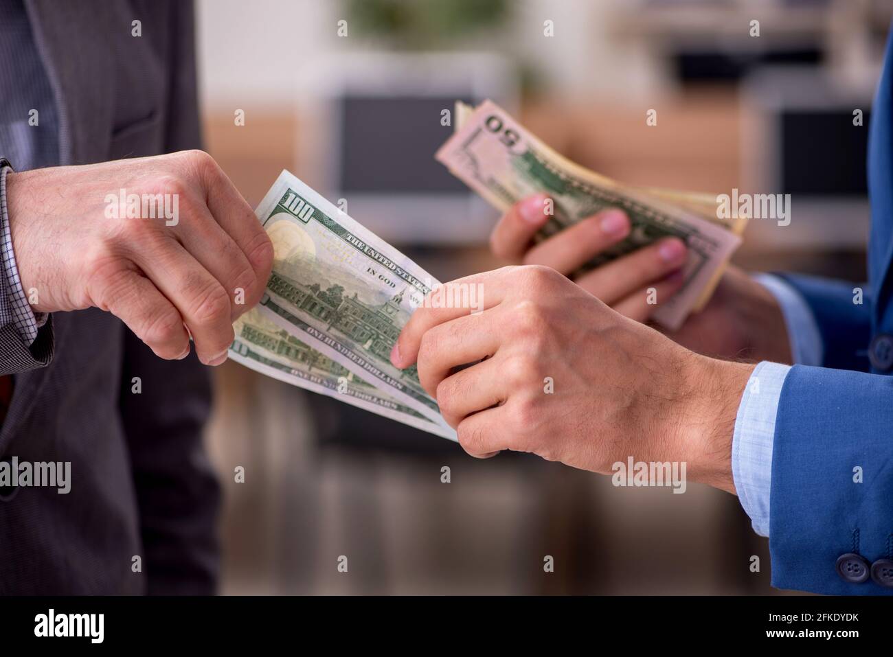 Two employees in remuneration concept Stock Photo - Alamy