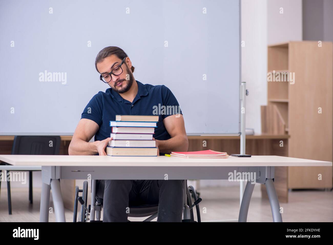 Young handicapped student in the classroom Stock Photo - Alamy