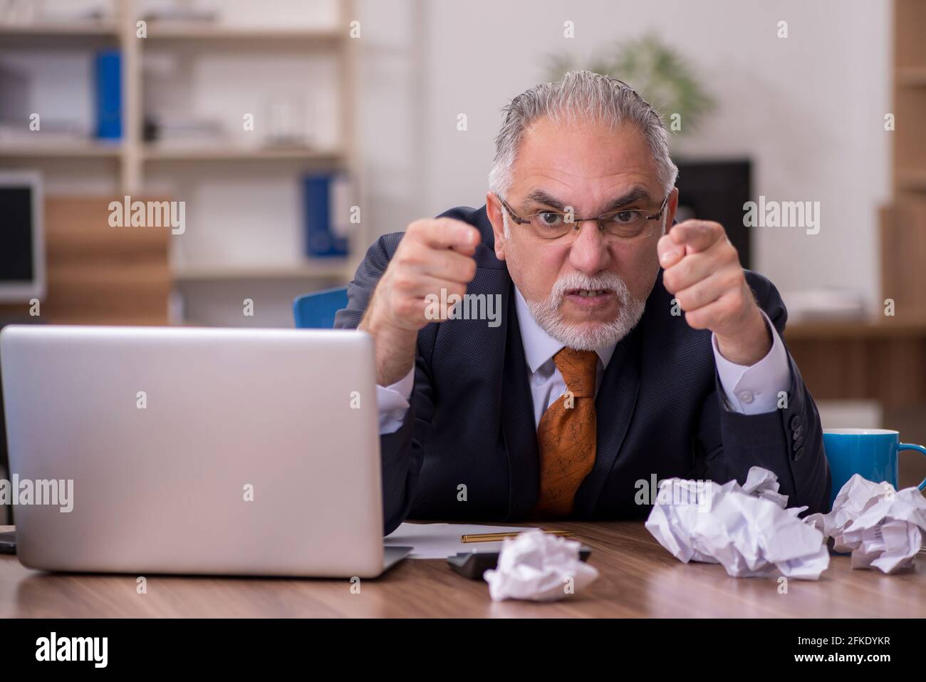 Old employee in paper recycling concept Stock Photo - Alamy