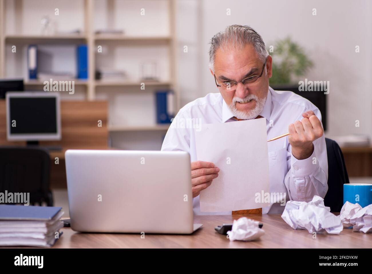 Old employee in paper recycling concept Stock Photo - Alamy
