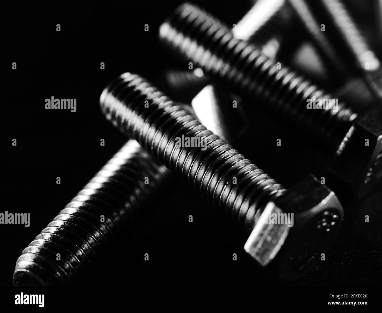 Studio grayscale of screws on black background Stock Photo - Alamy