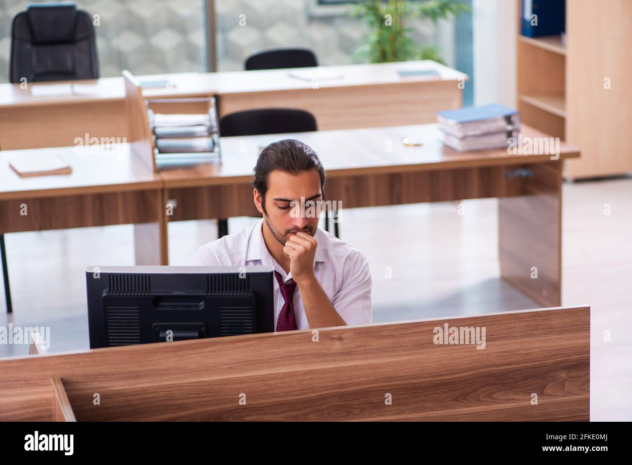 Young employee and too many work in the office Stock Photo - Alamy