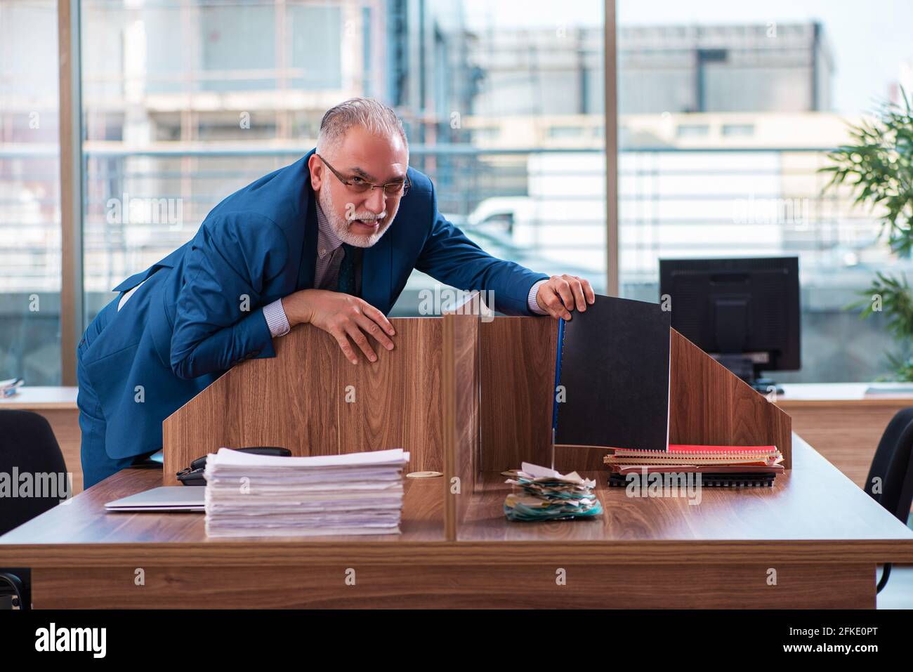 Old employee working in the office Stock Photo - Alamy