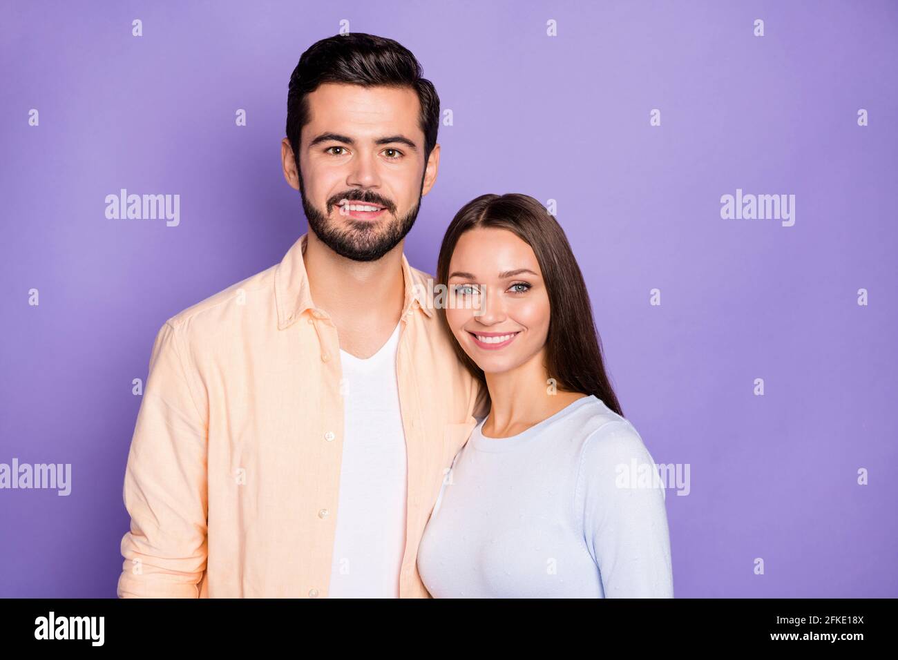 Portrait of two satisfied persons standing close toothy smile look ...