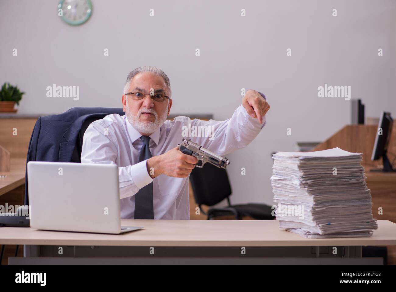 Old employee being desperate with excessive work in the office Stock ...
