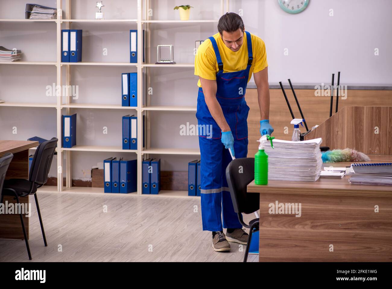 Male contractor cleaning the office Stock Photo - Alamy