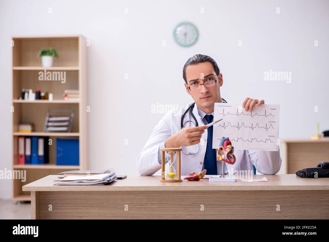 Young doctor cardiologist looking electrocardiogram Stock Photo - Alamy