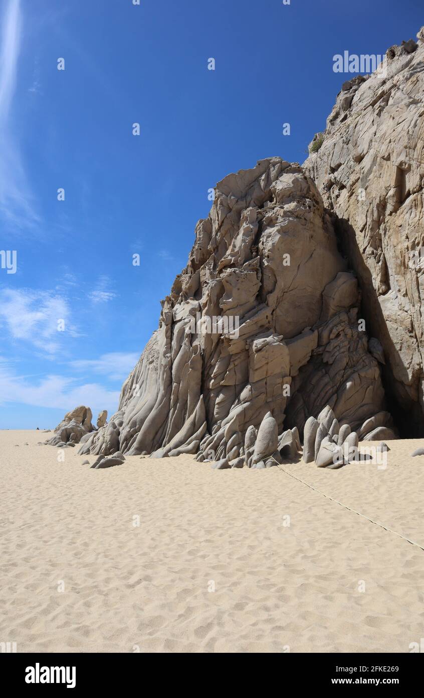 Pacific ocean and beach with golden sands and limestone rock formations ...