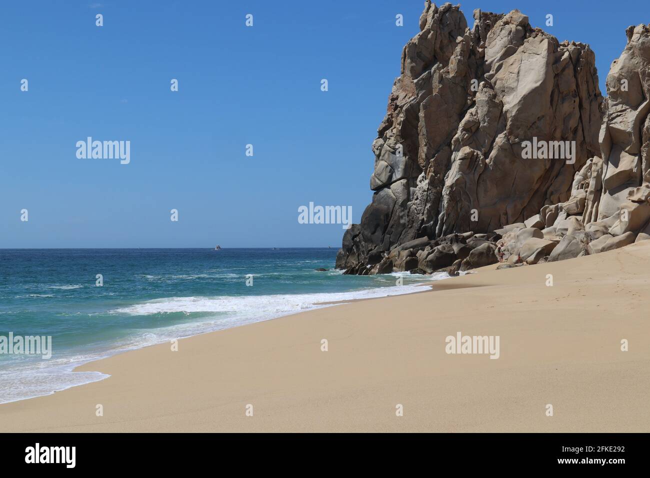 Pacific ocean and beach with golden sands and limestone rock formations ...
