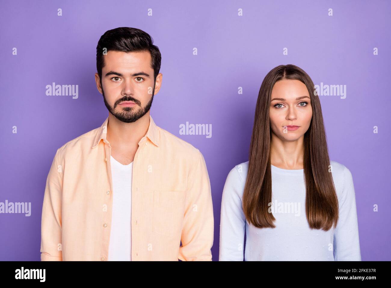 Portrait of two persons stand together look camera no emotions face ...