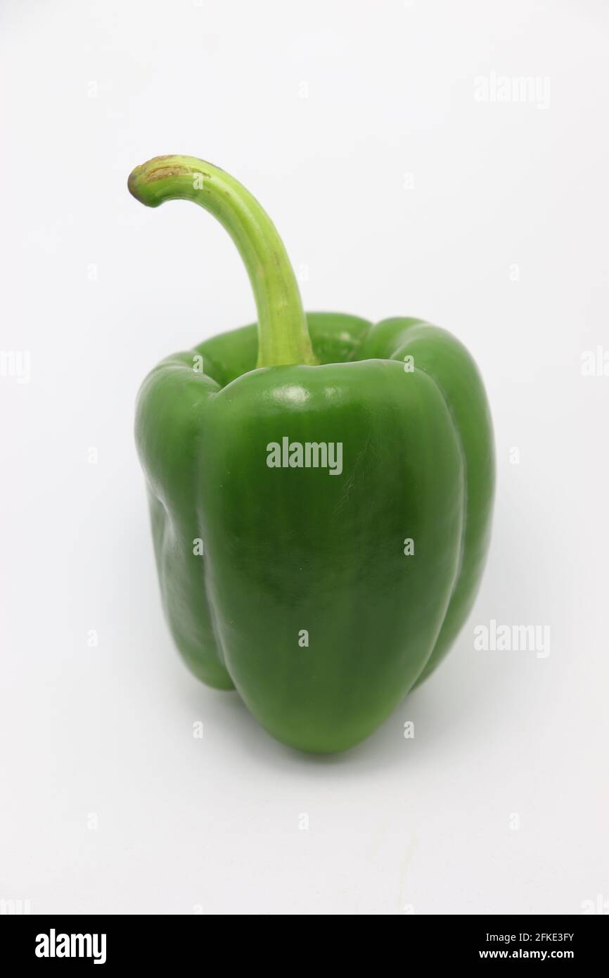 green colored capsicum closeup on white background Stock Photo - Alamy