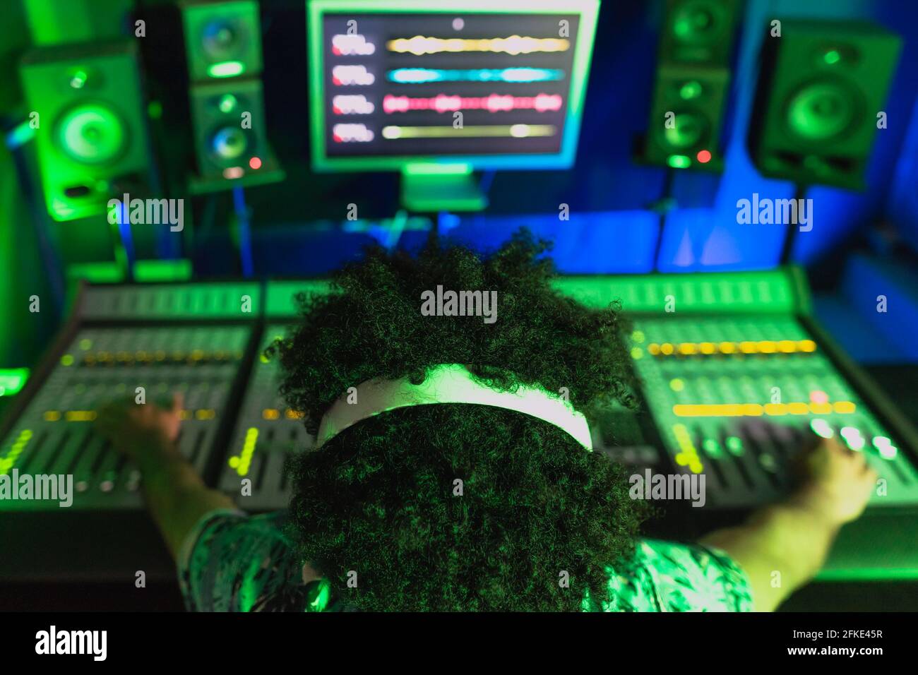 Young Afro man working in music recording studio - Male audio engineer ...