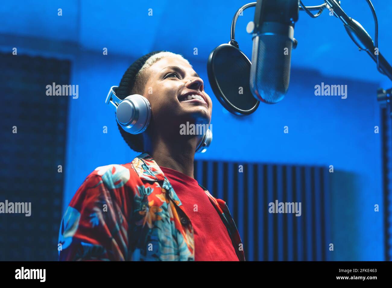 Young professional female singer recording a new song album inside ...