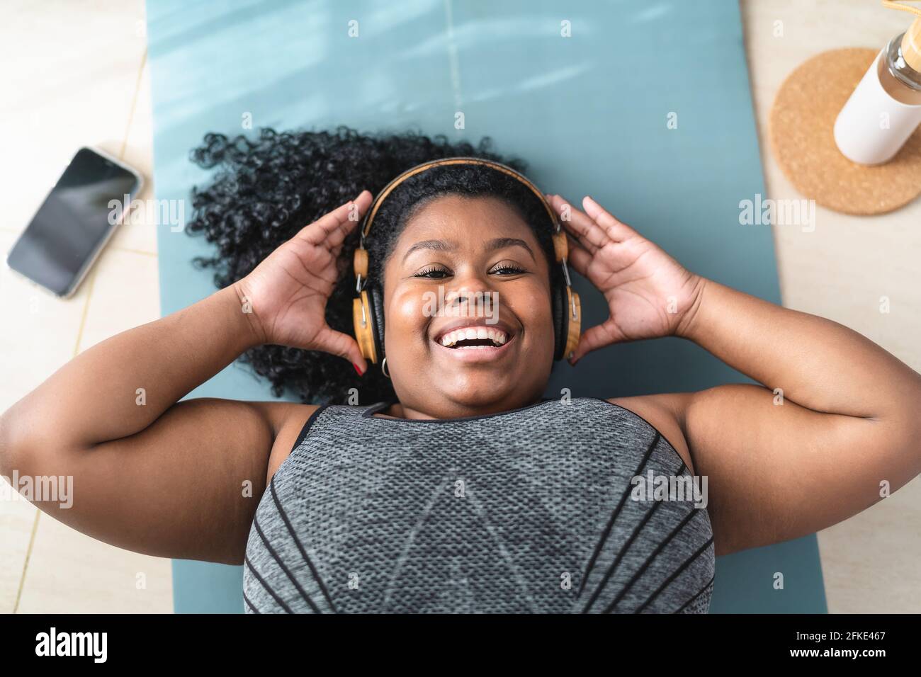 Happy African Woman Having Fun Listening Music With Headphones While