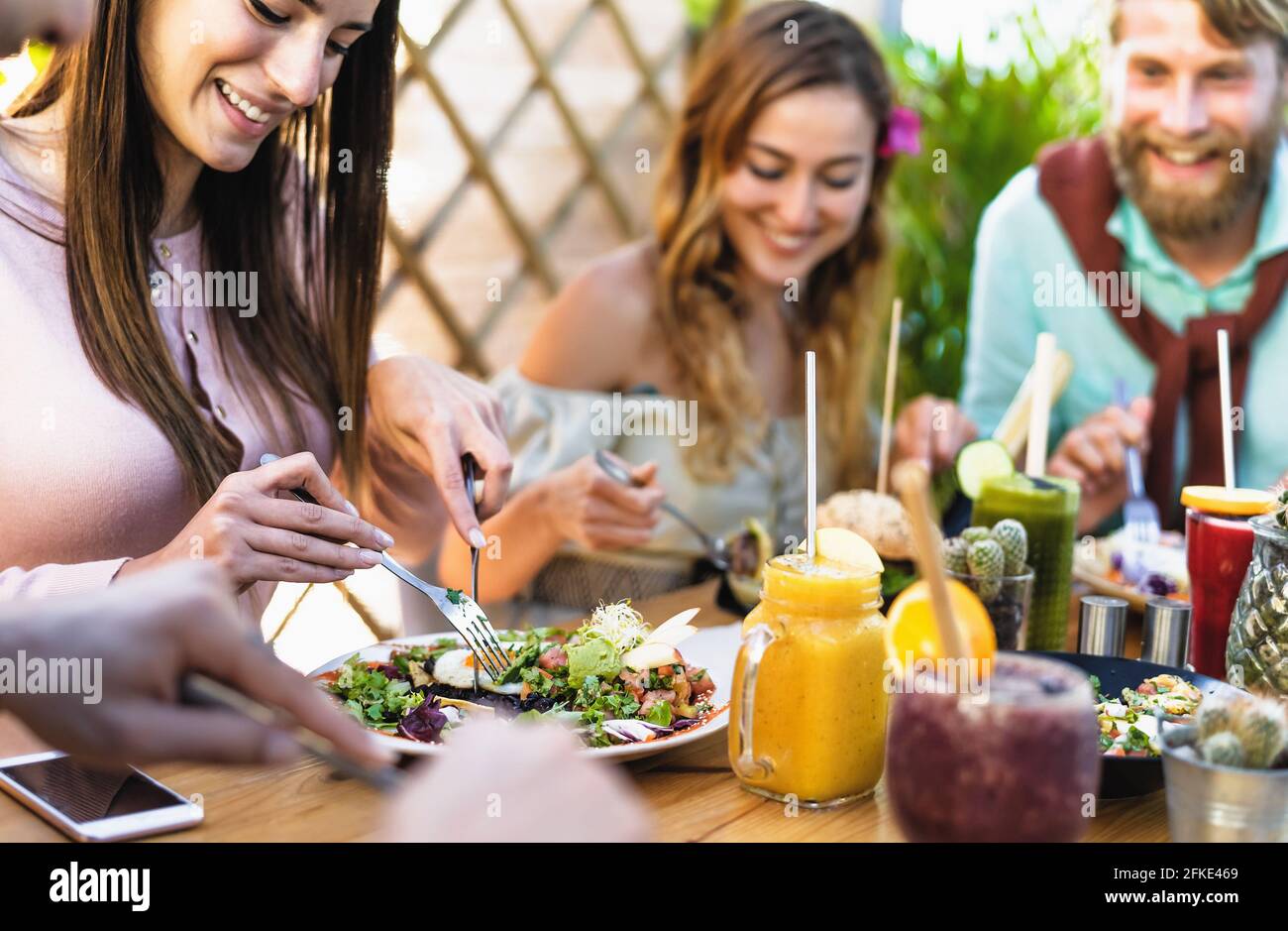 Happy friends lunching with healthy food in bar coffee brunch - Young ...