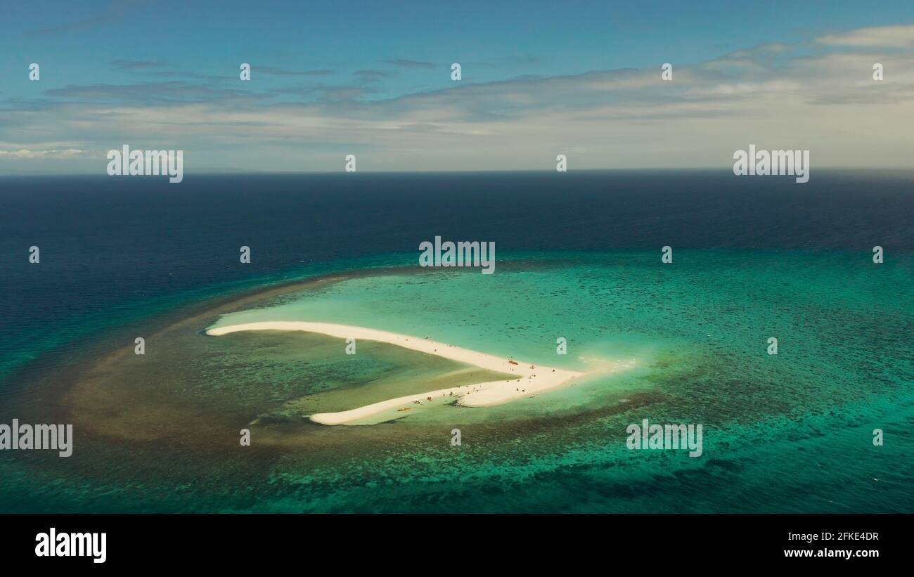 Tropical white island and sandy beach with tourists surrounded by coral ...