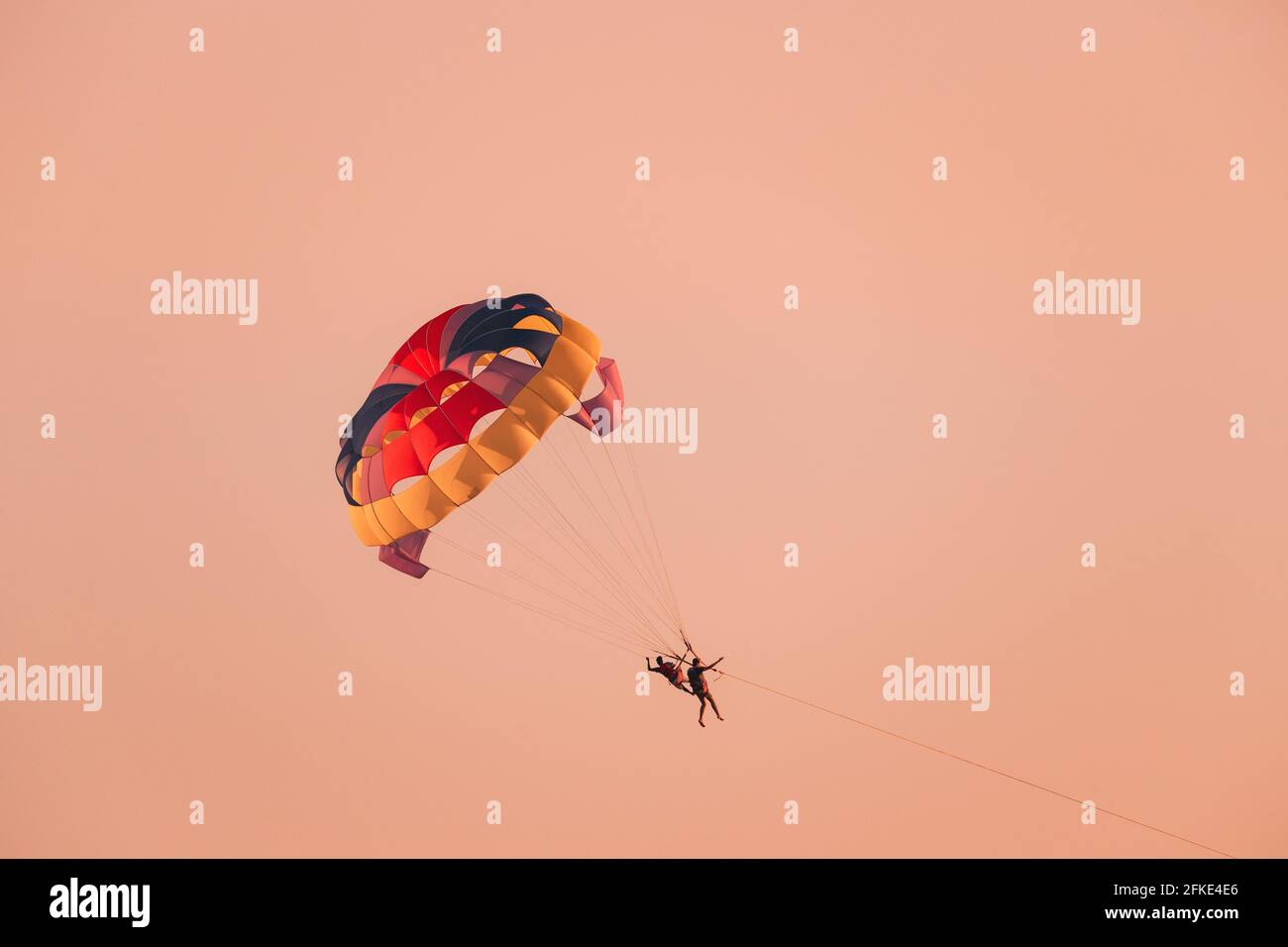 Parasailers Flying On Colorful Parachute In Sunset Or Sunrise Sky ...