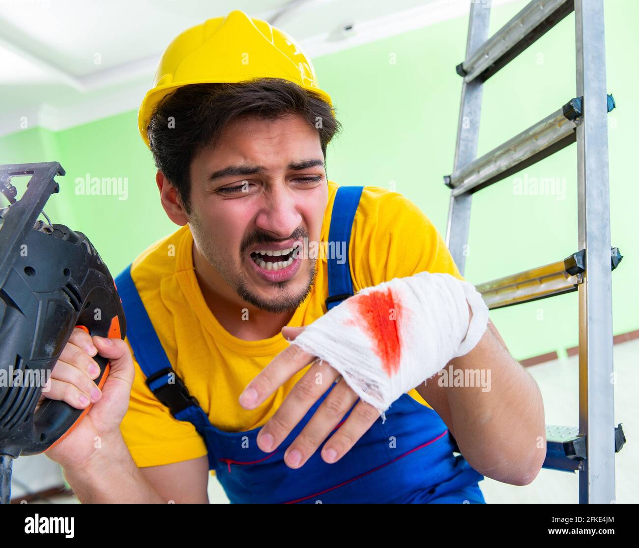 The injured worker at the work site Stock Photo - Alamy