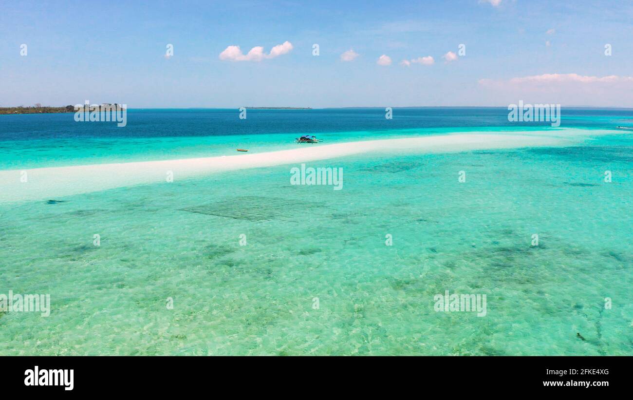 White sandy beach in the lagoon with turquoise water on a tropical ...