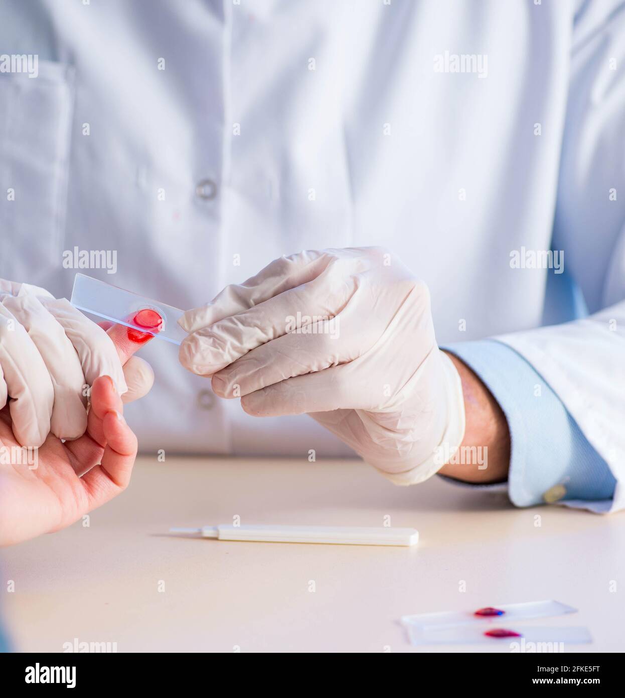 The doctor taking blood samples from finger Stock Photo - Alamy