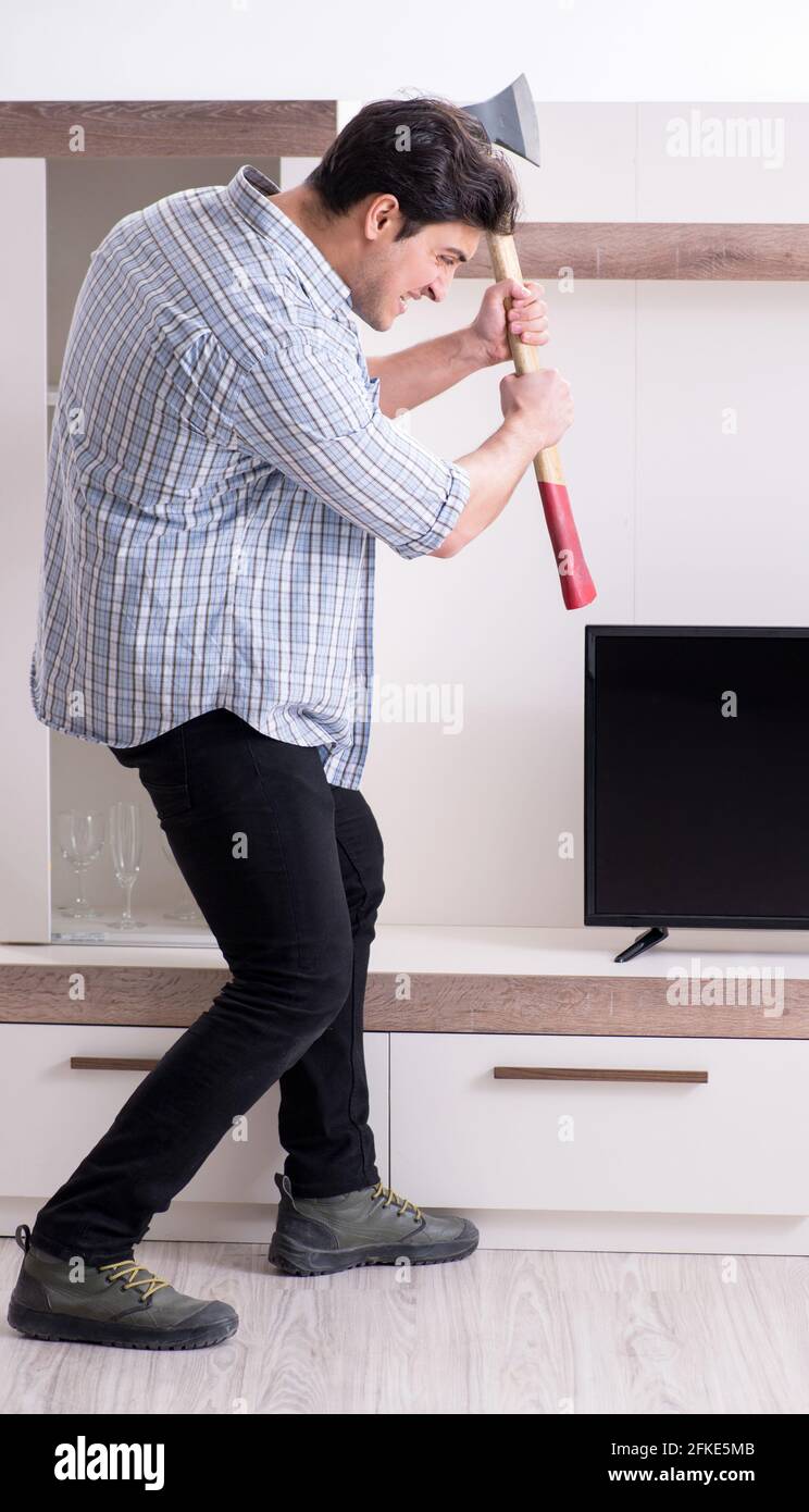 The man trying to fix broken tv Stock Photo - Alamy