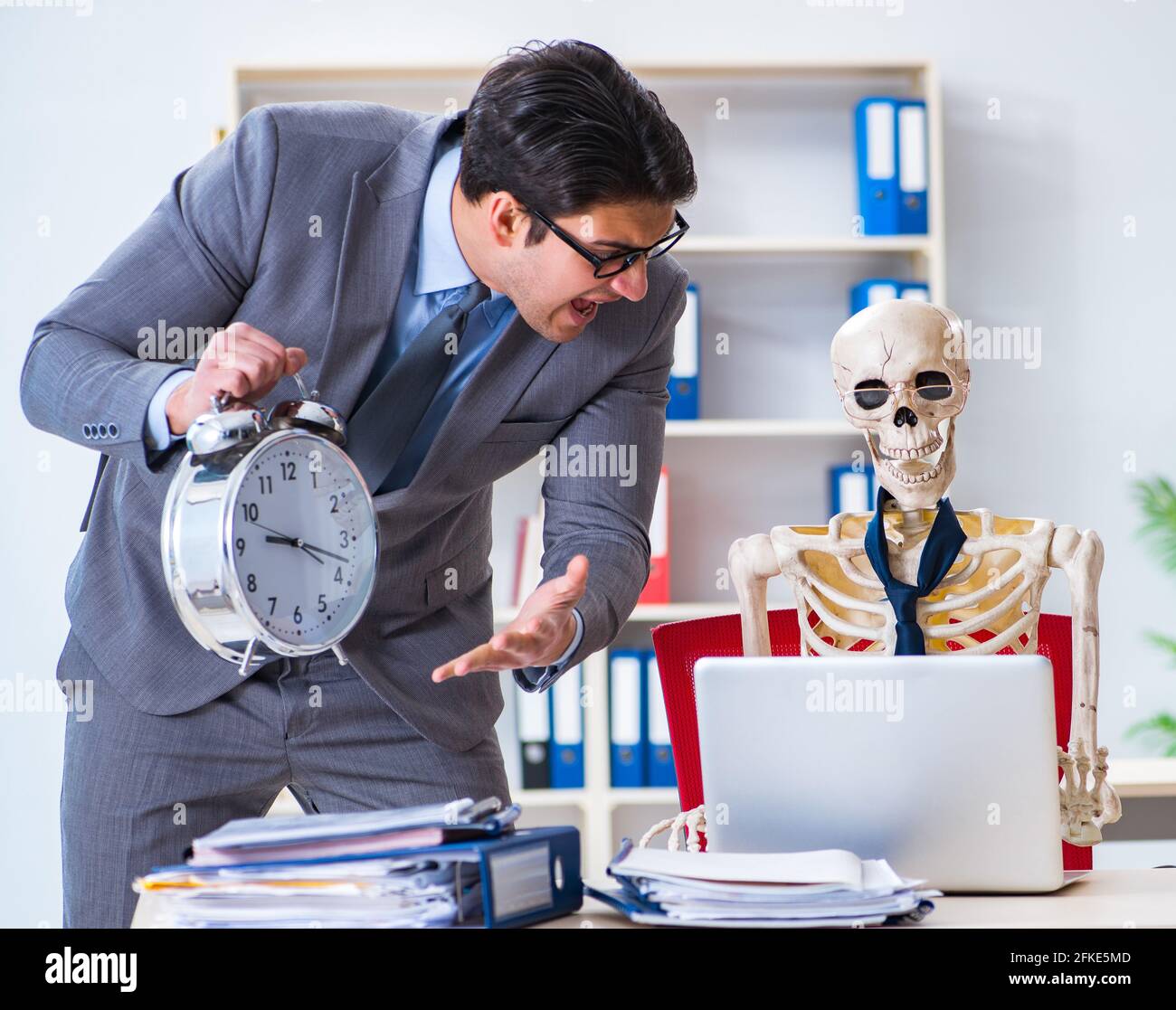 The angry boss yelling at his skeleton employee Stock Photo - Alamy